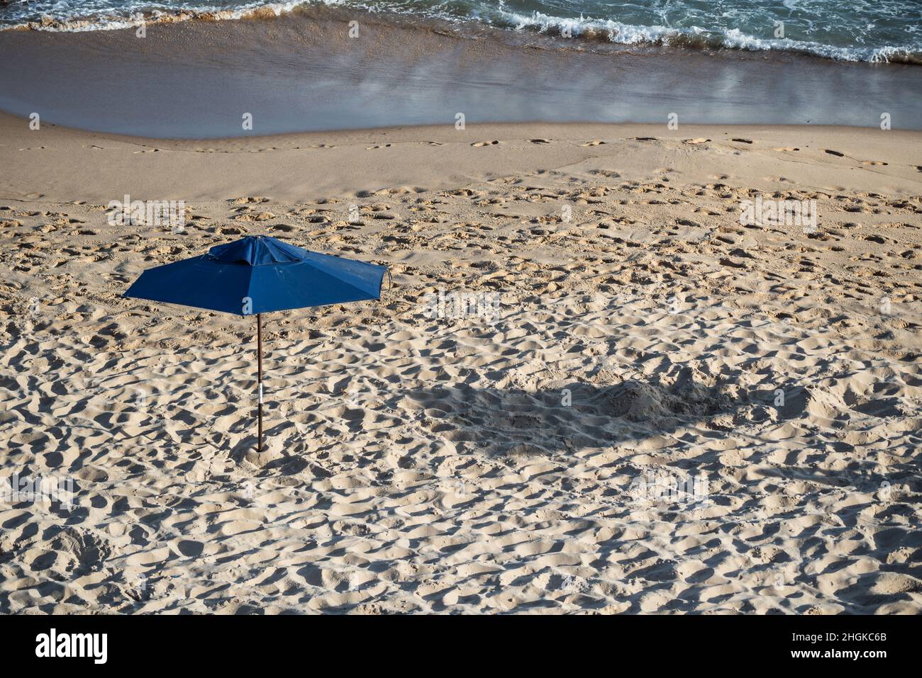 Sunshade on the beach in the strong sun of the day. Paciencia Beach in ...
