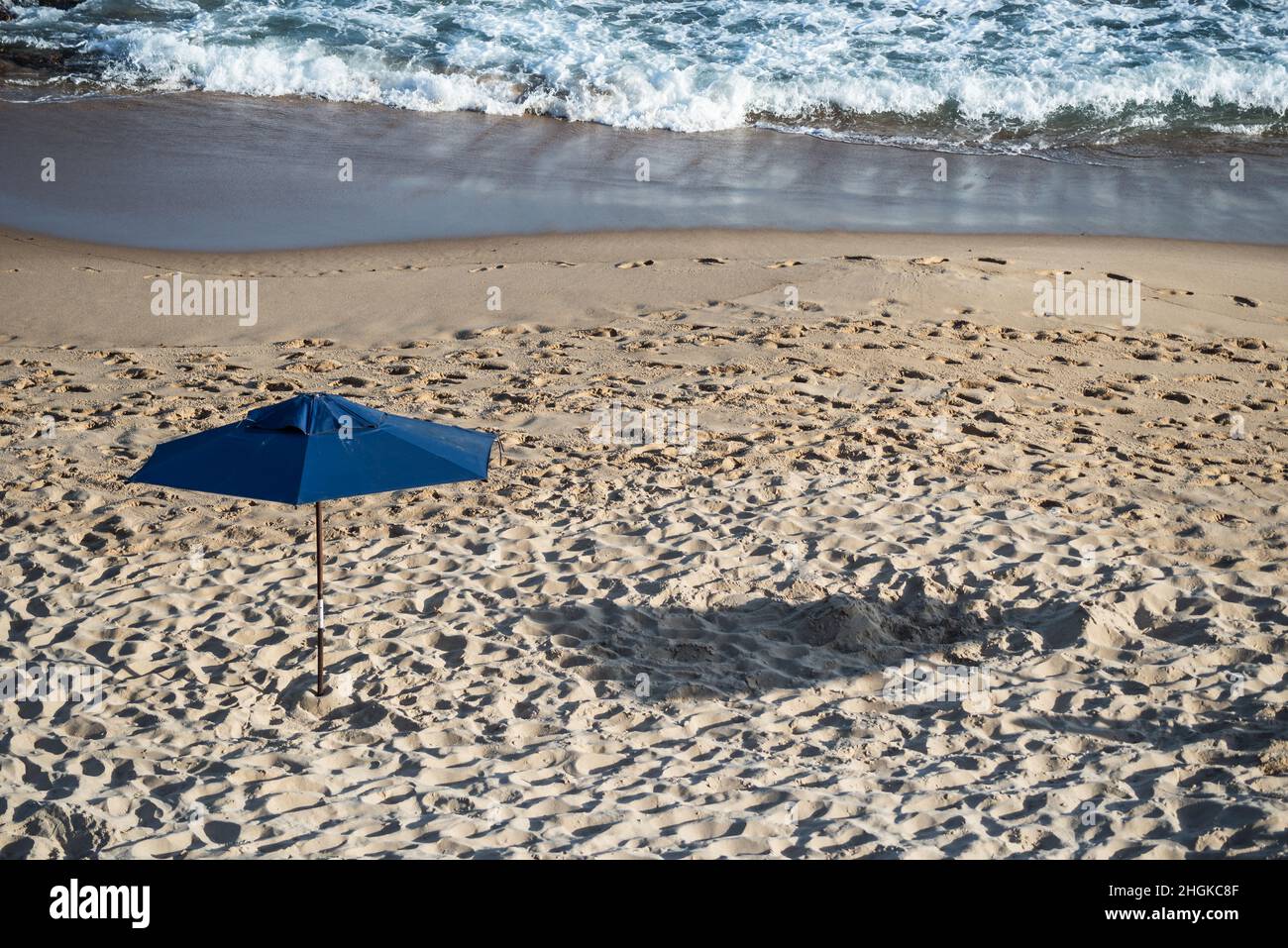 Sunshade on the beach in the strong sun of the day. Paciencia Beach in ...