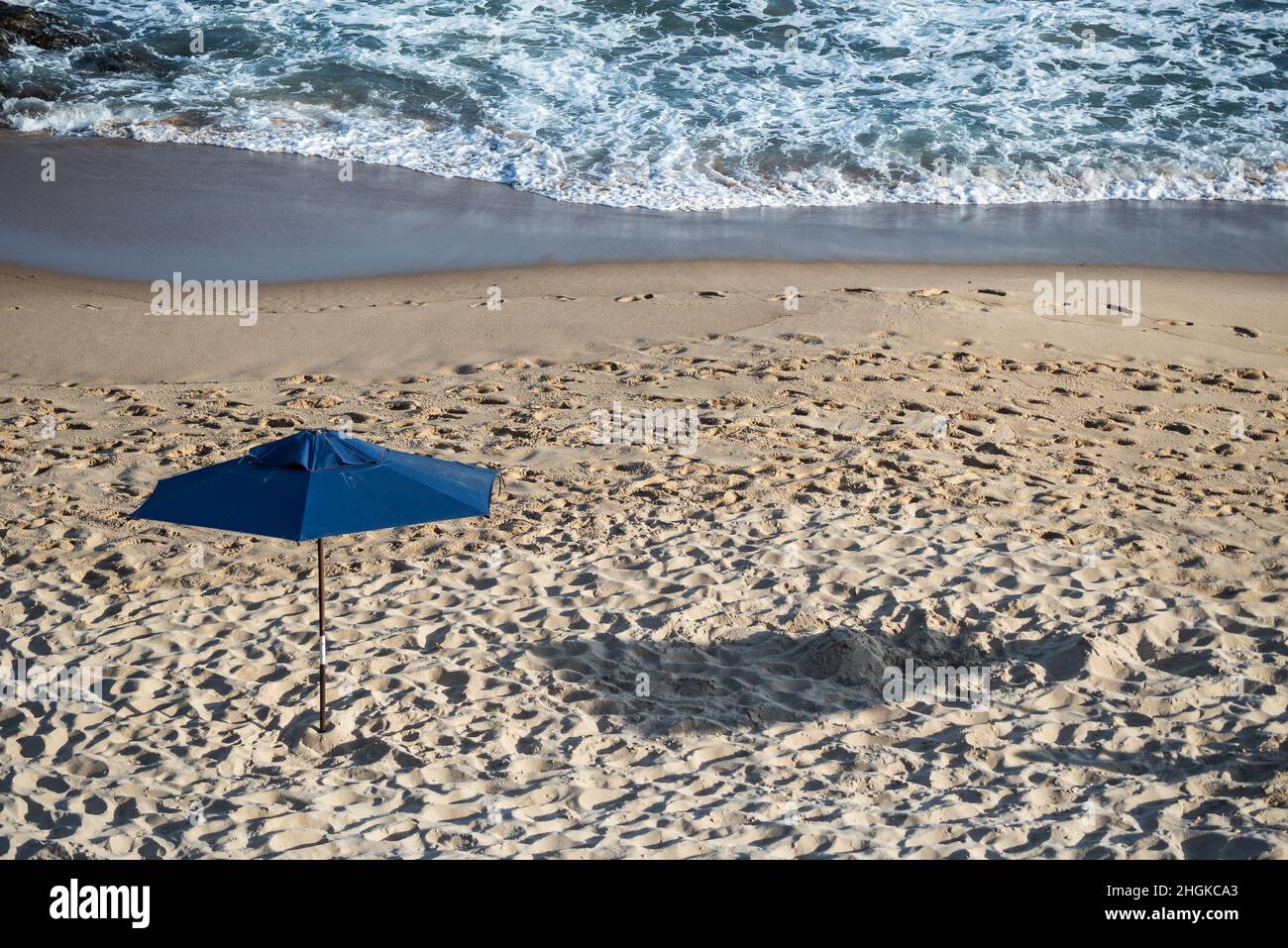 Sunshade on the beach in the strong sun of the day. Paciencia Beach in ...