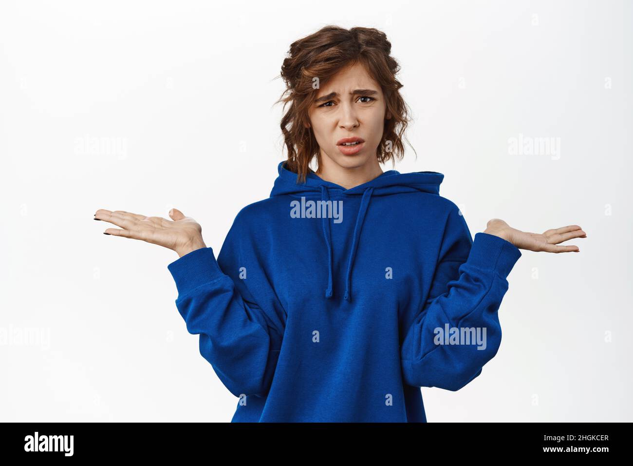 Image of confused young woman shrugging, looking puzzled and clueless ...