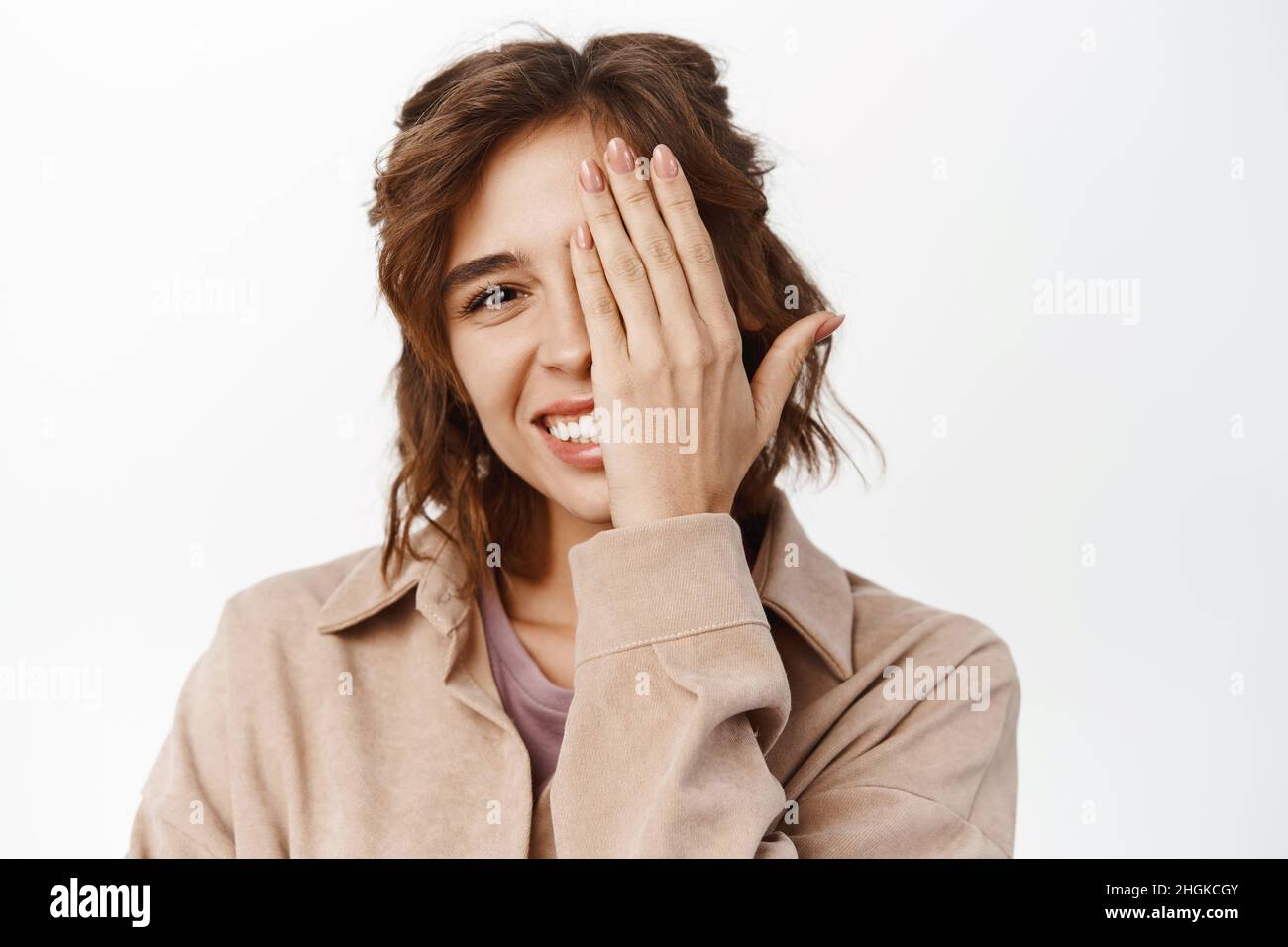 Close up portrait of young woman close one side of face, cover eye and ...