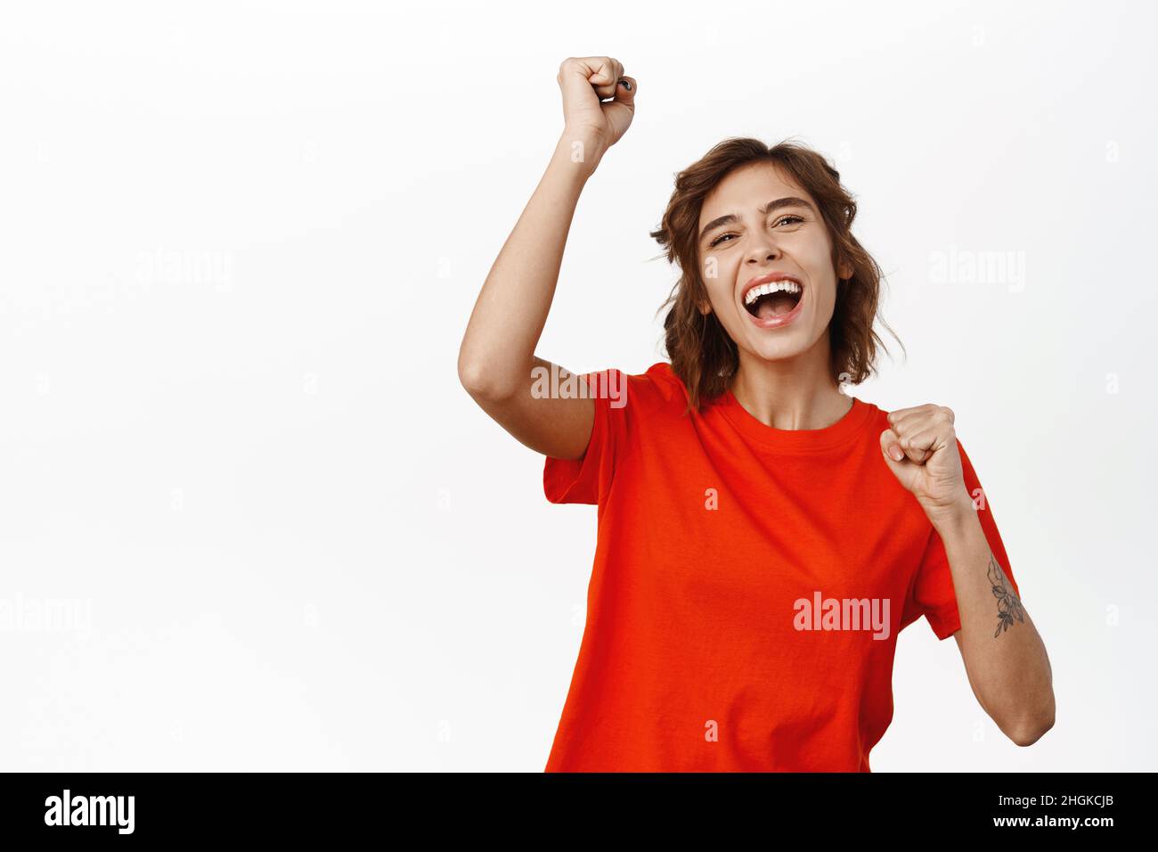 Enthusiastic girl cheering, winning and celebrating, scream of joy ...