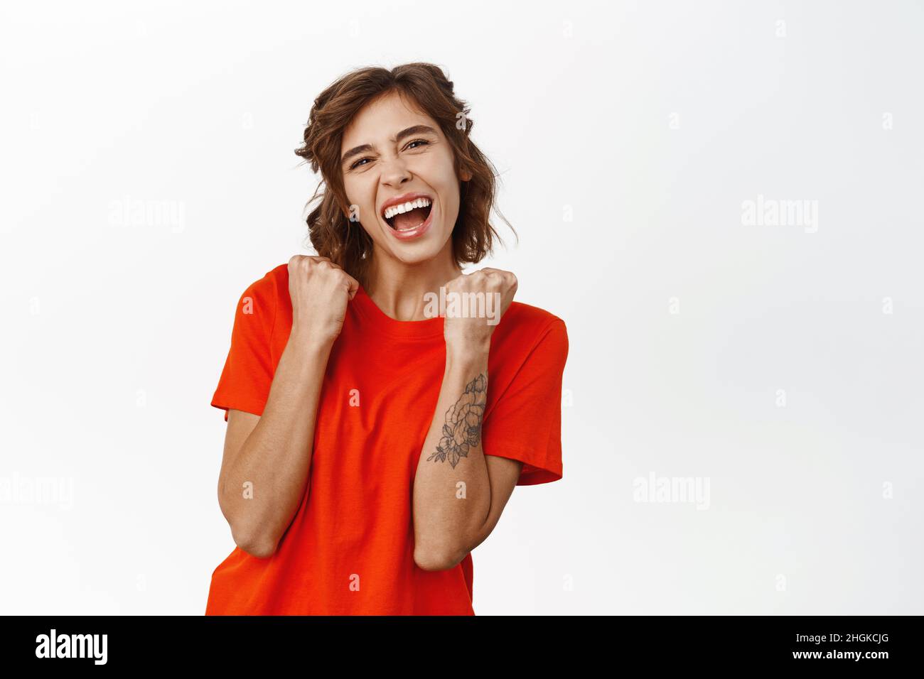 Enthusiastic girl cheering, winning and celebrating, scream of joy ...