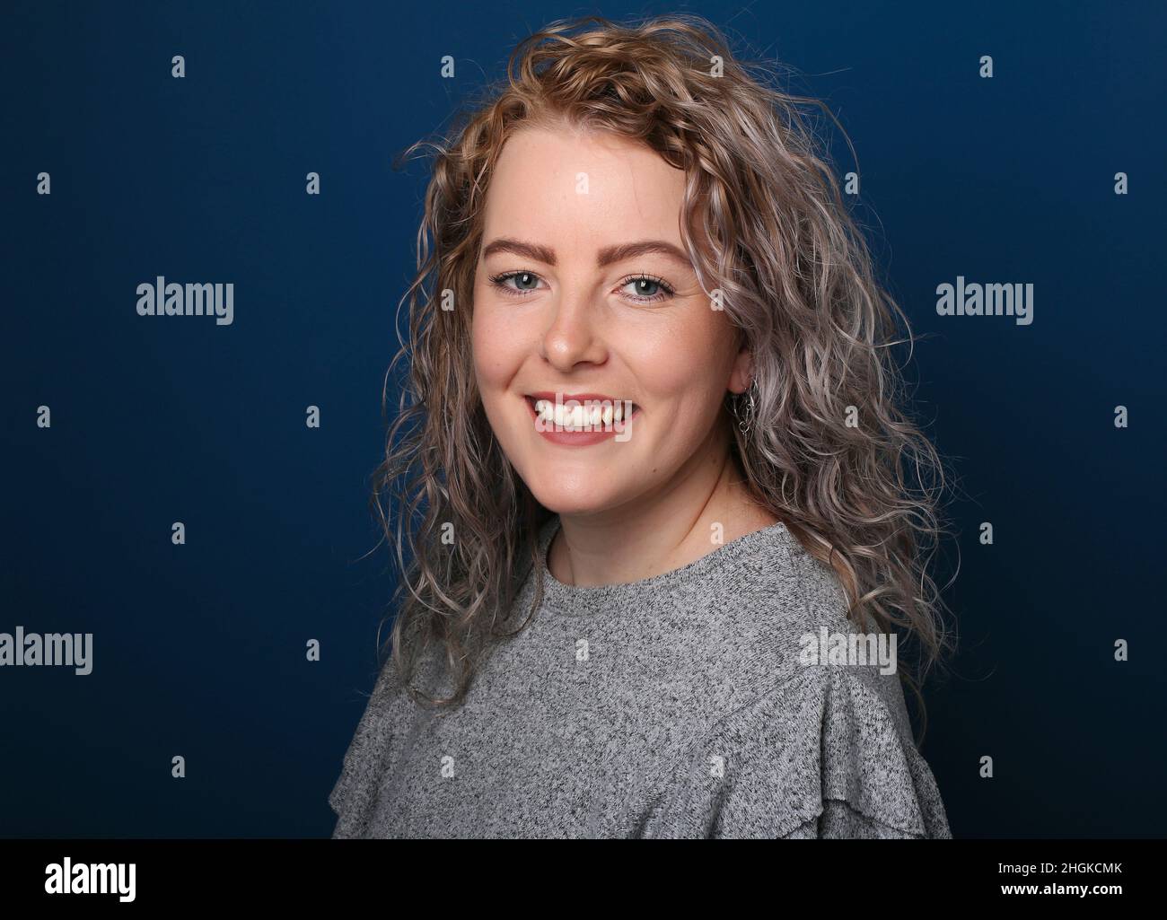 Portrait of a beautiful happy woman in front of a colored background ...