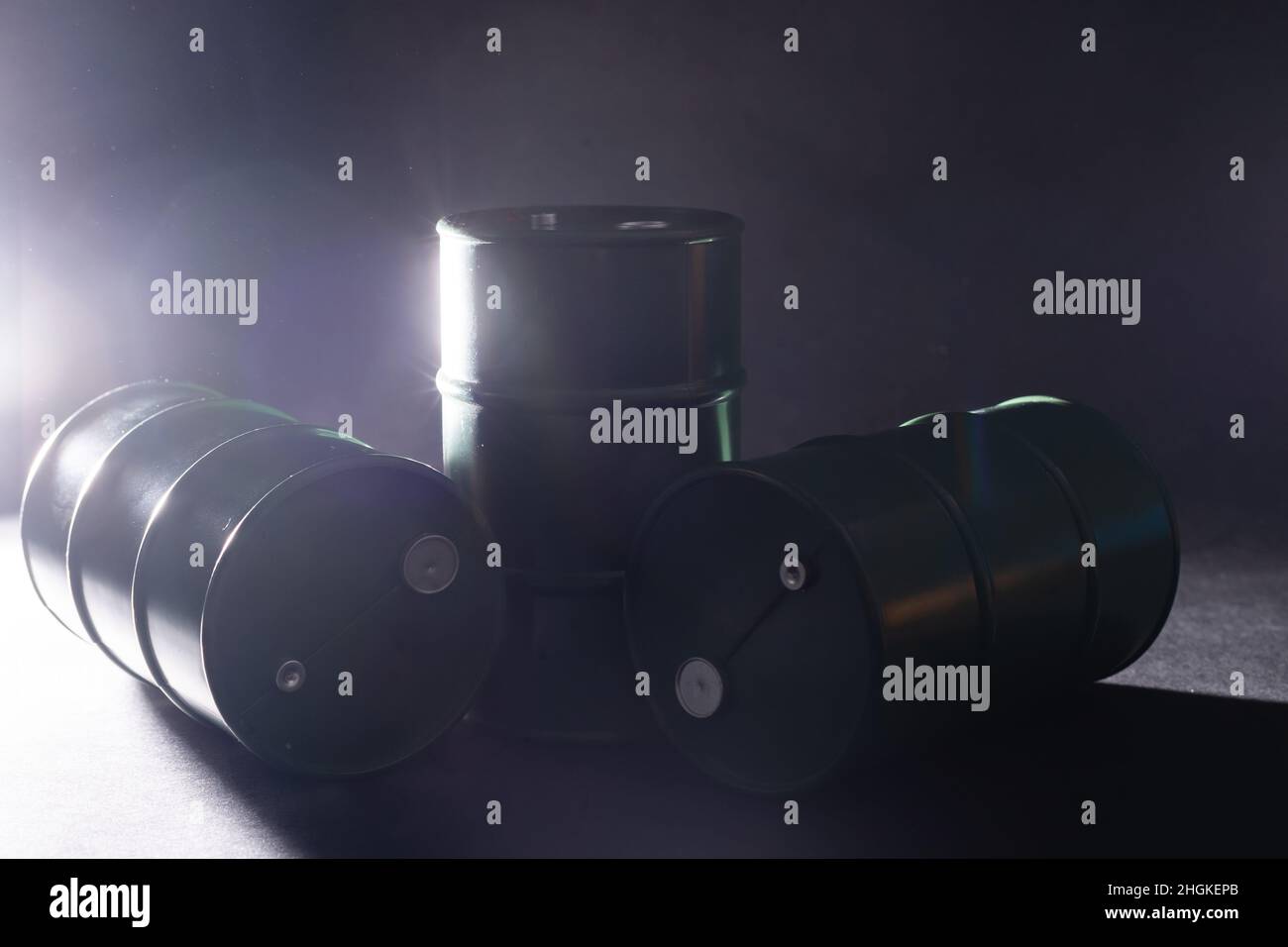 green oil tin barrels on black background Stock Photo - Alamy