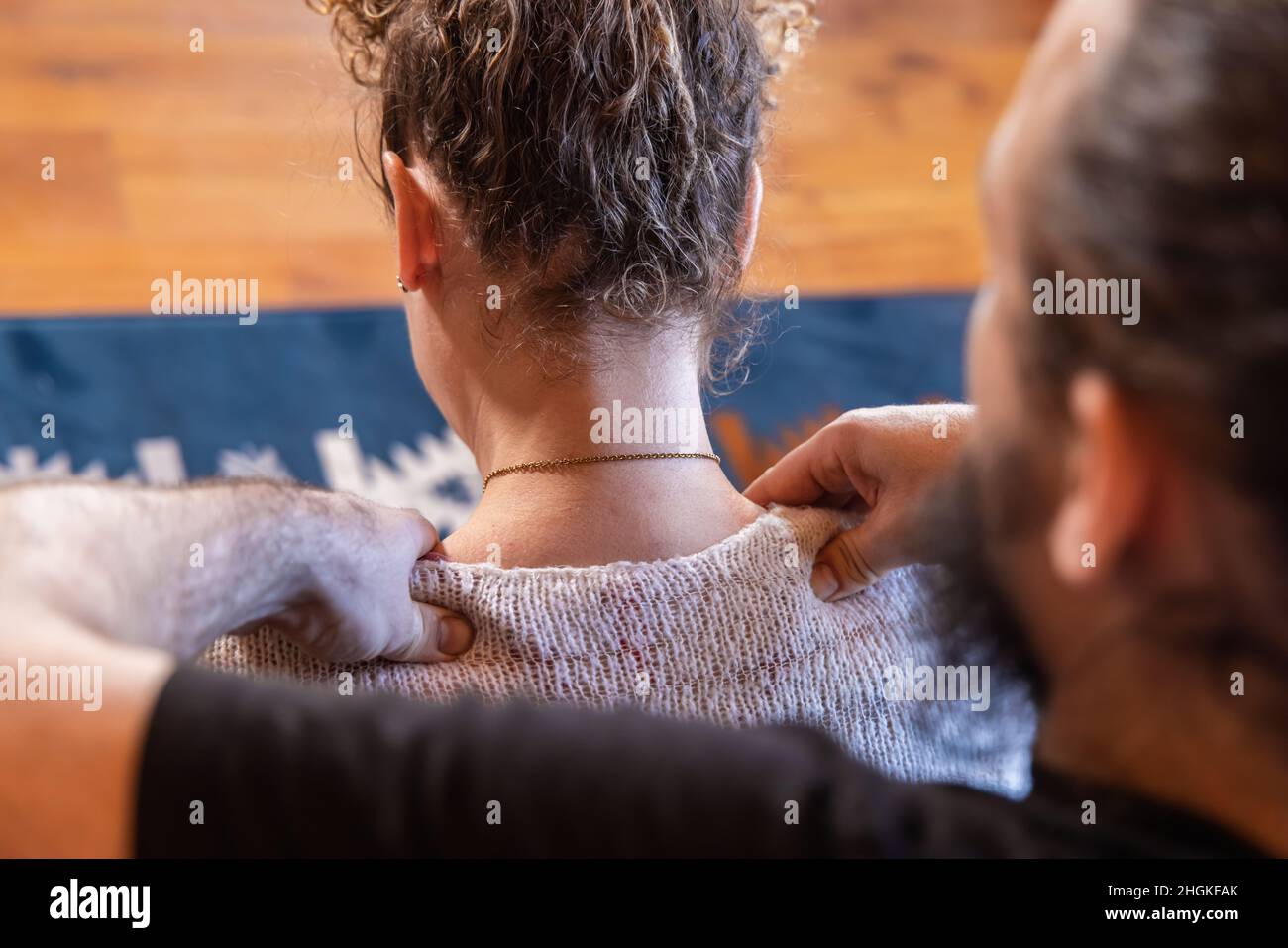 Selective focus and up close view of a man using petrissage kneading ...