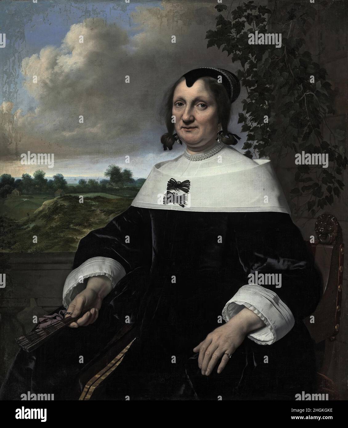 Portrait of Maria van Arckel, three-quarter-length, seated, before a ...