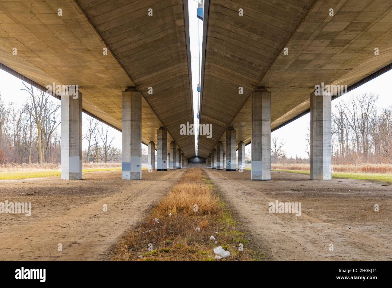 Central view from under of highway bridge with high concrete pillars ...