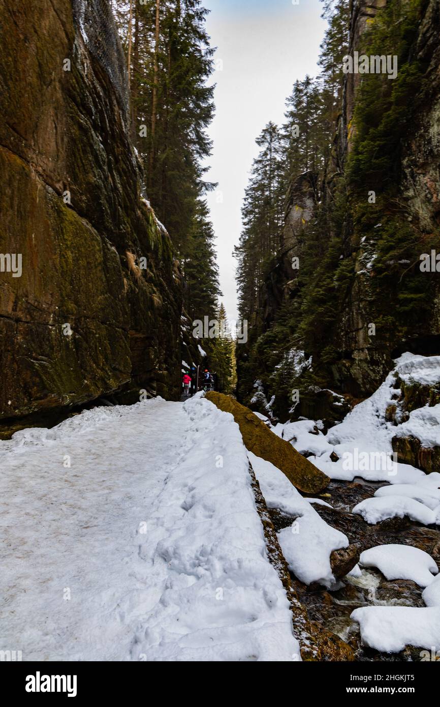 Small footbridge over mountain river between high rocks as path to ...