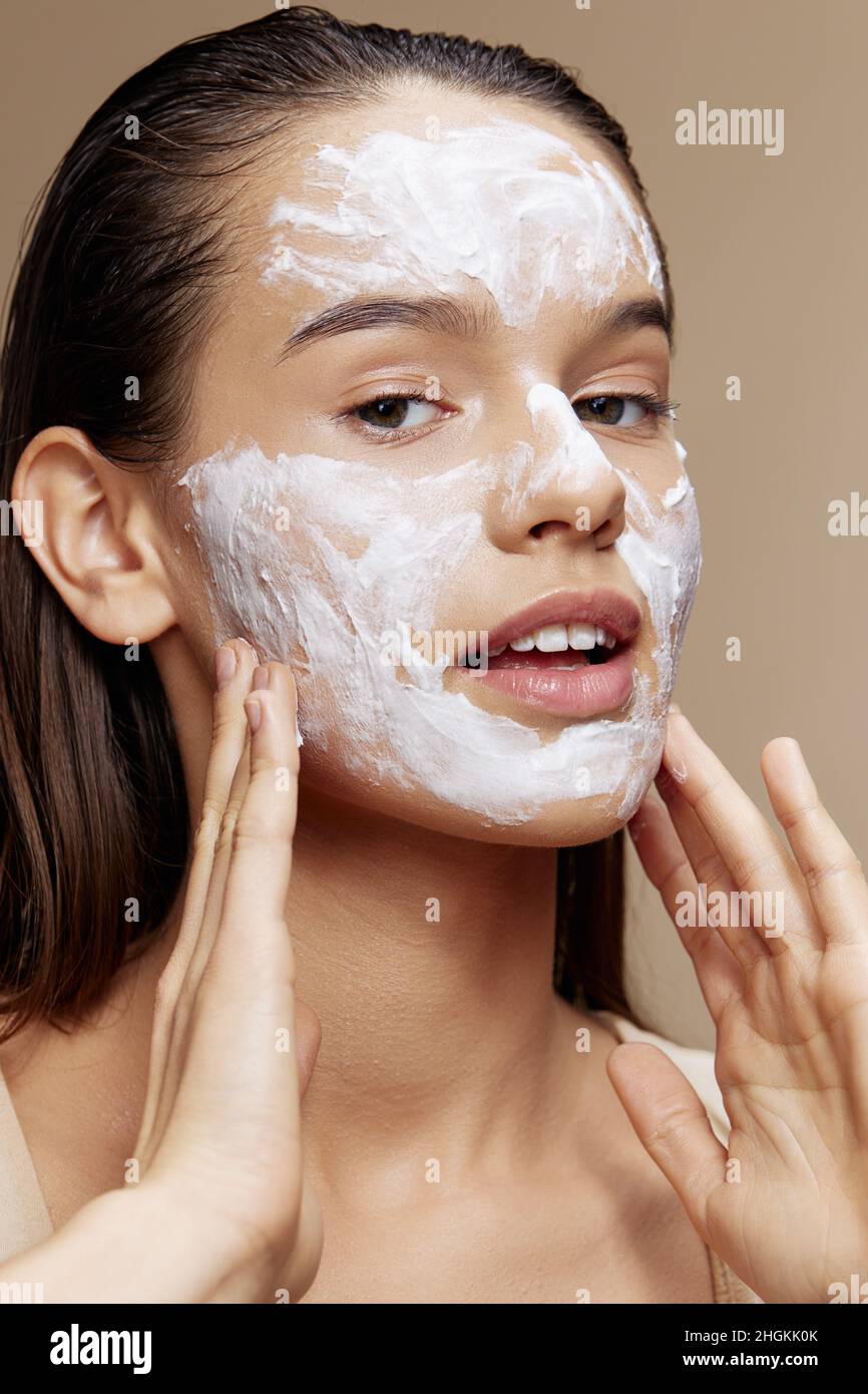 brunette applying a soothing face mask cosmetic Youth and Skin Care Concept Stock Photo - Alamy