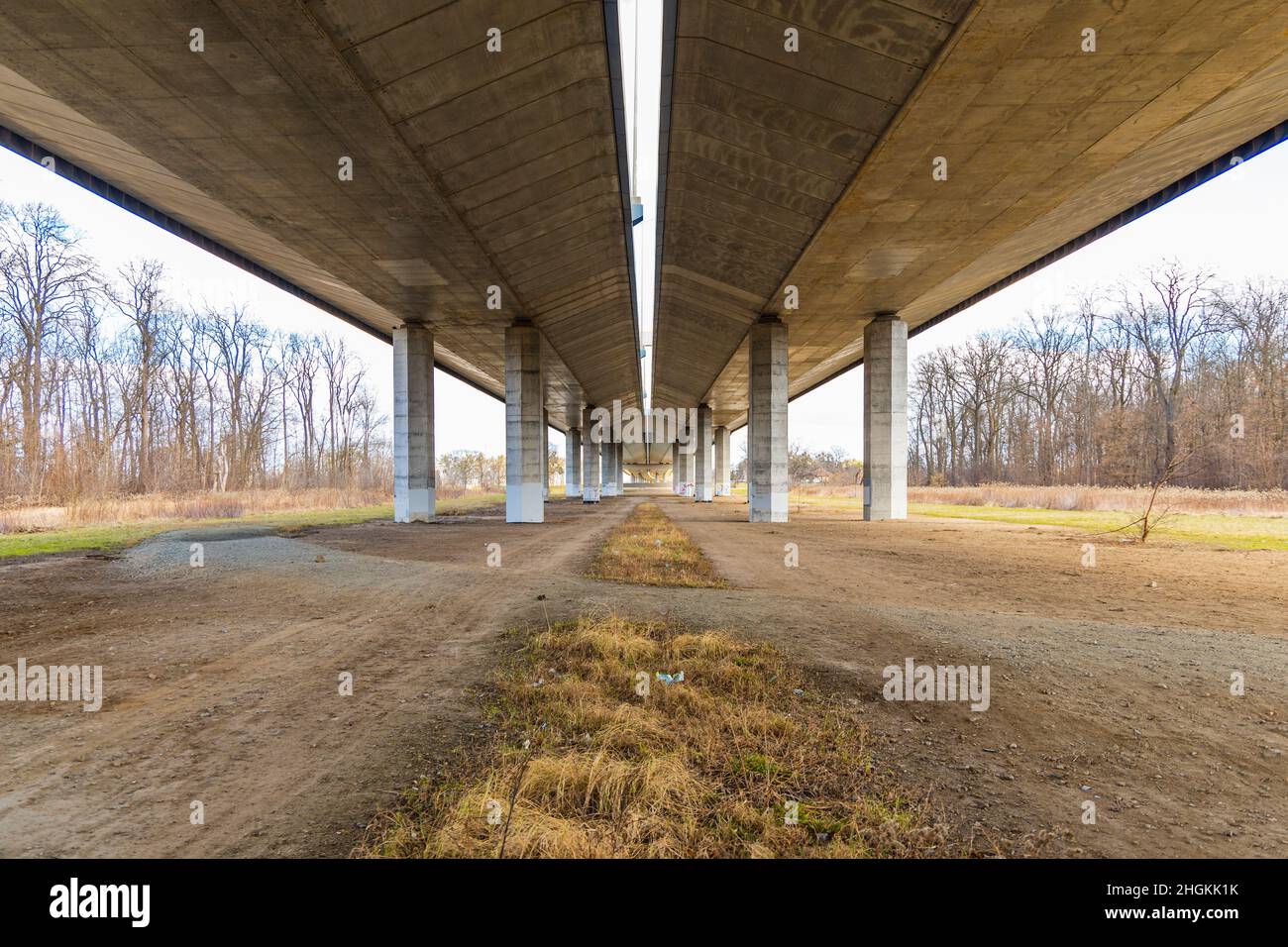 Central view from under of highway bridge with high concrete pillars ...