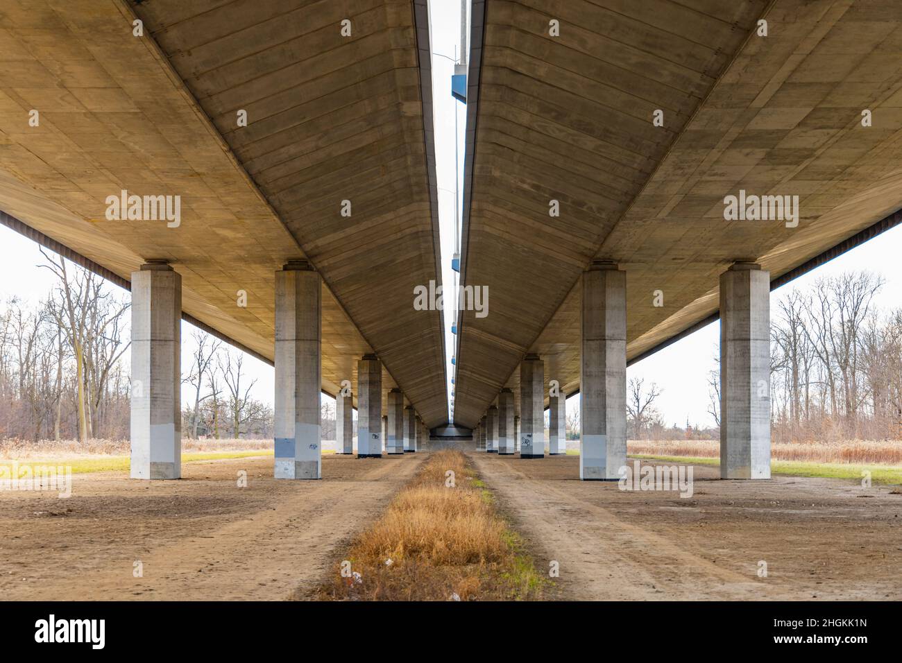 Central view from under of highway bridge with high concrete pillars ...