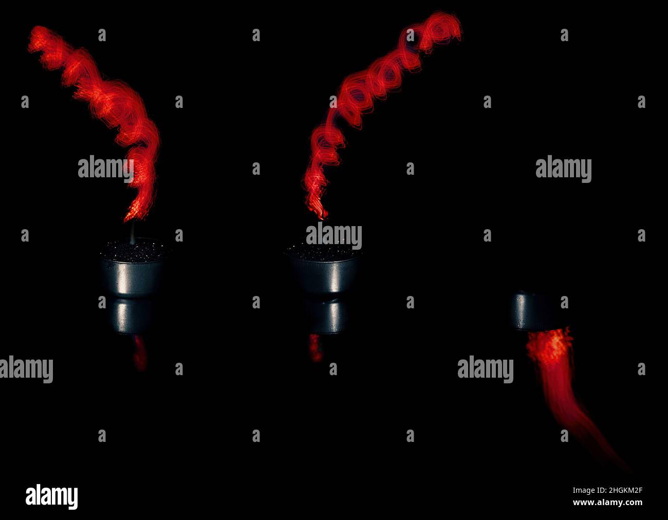 Three candles light painted with one showing the surface reflection ...