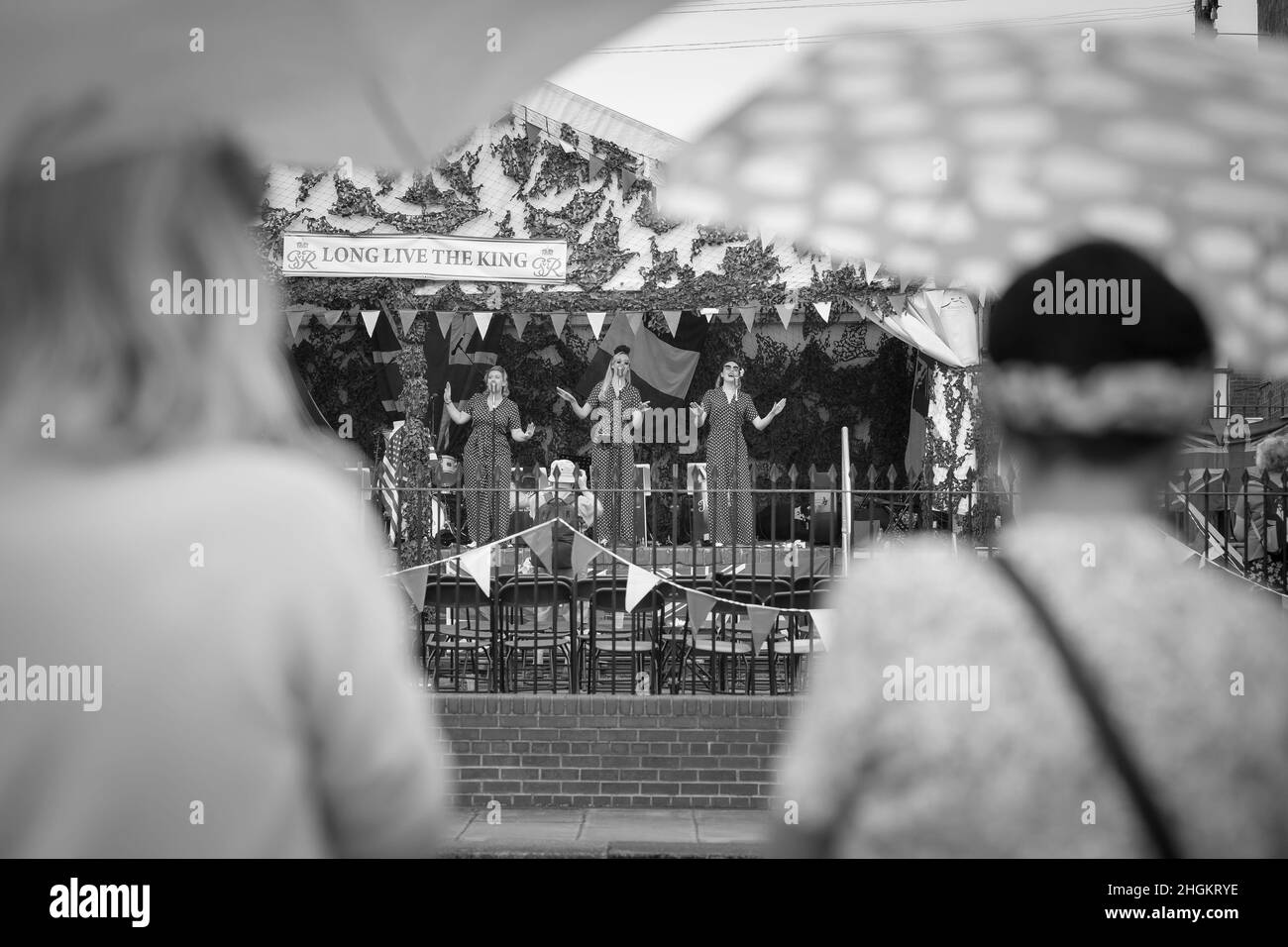 Trio of female singers performing on stage at 1940s reenactment event ...