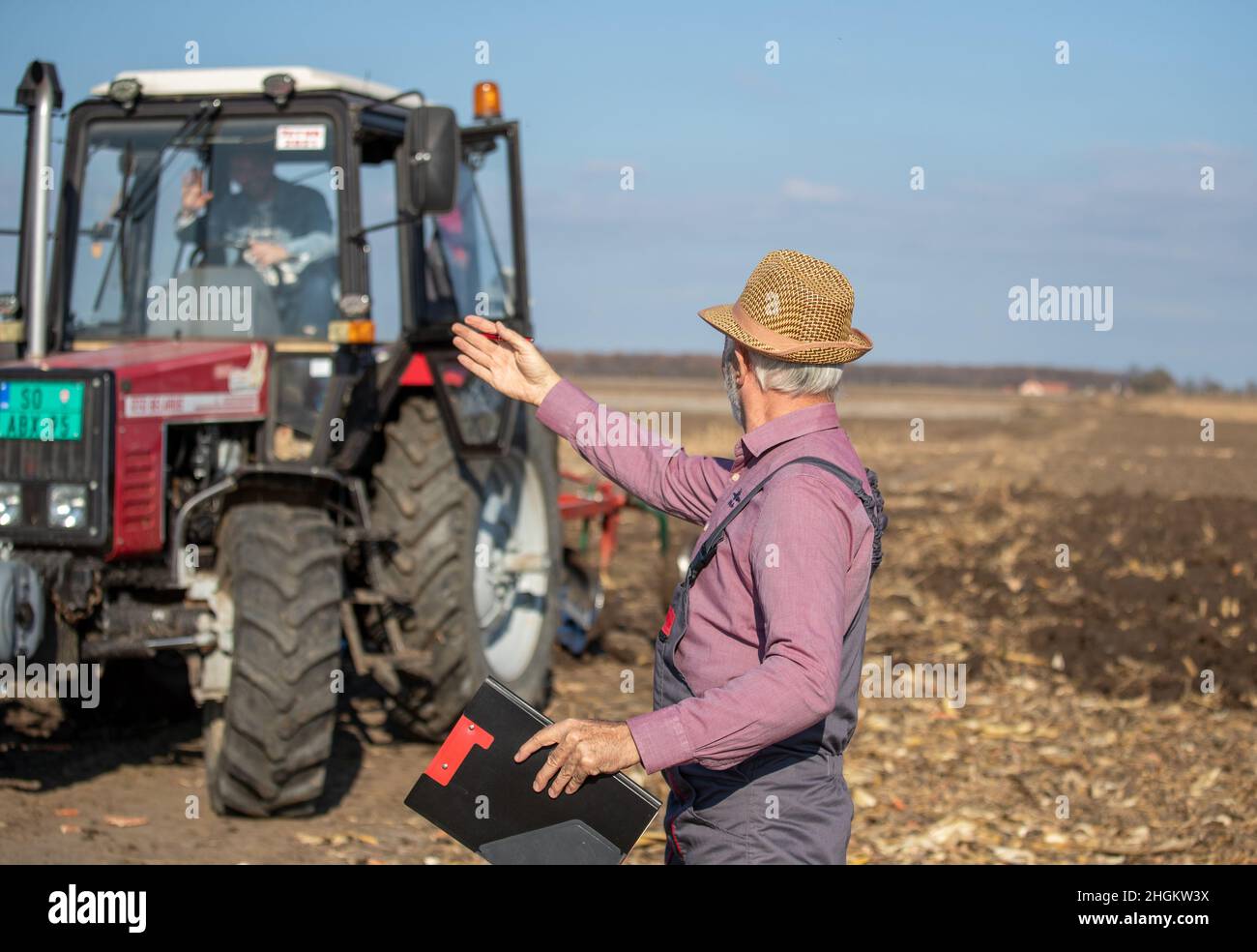 Senior farmer driving tractor hi-res stock photography and images - Alamy