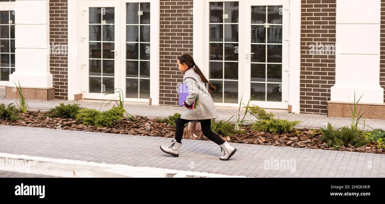 happy little girl running home from school Stock Photo - Alamy