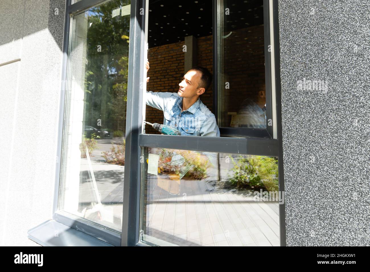 Male worker installing window in flat, closeup Stock Photo - Alamy