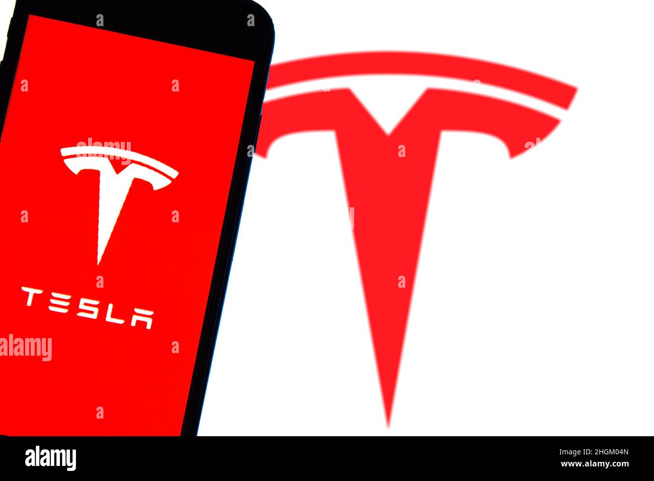 In this photo illustration a Tesla logo seen displayed on a smartphone ...
