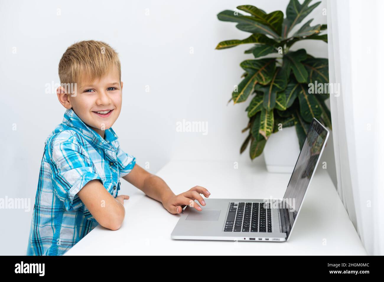 Closeup view of little kid talking with family via video chat at home ...
