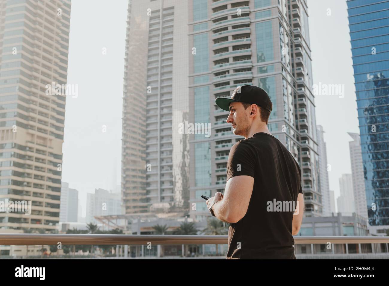 Young person standing outdoor and looking forward with urban background ...