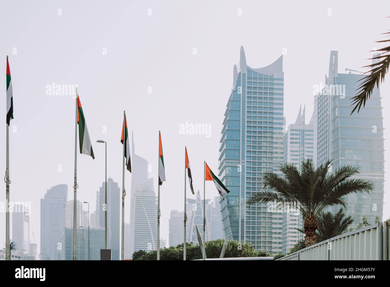 UAE national symbol flag waving outdoor with city and sky background ...