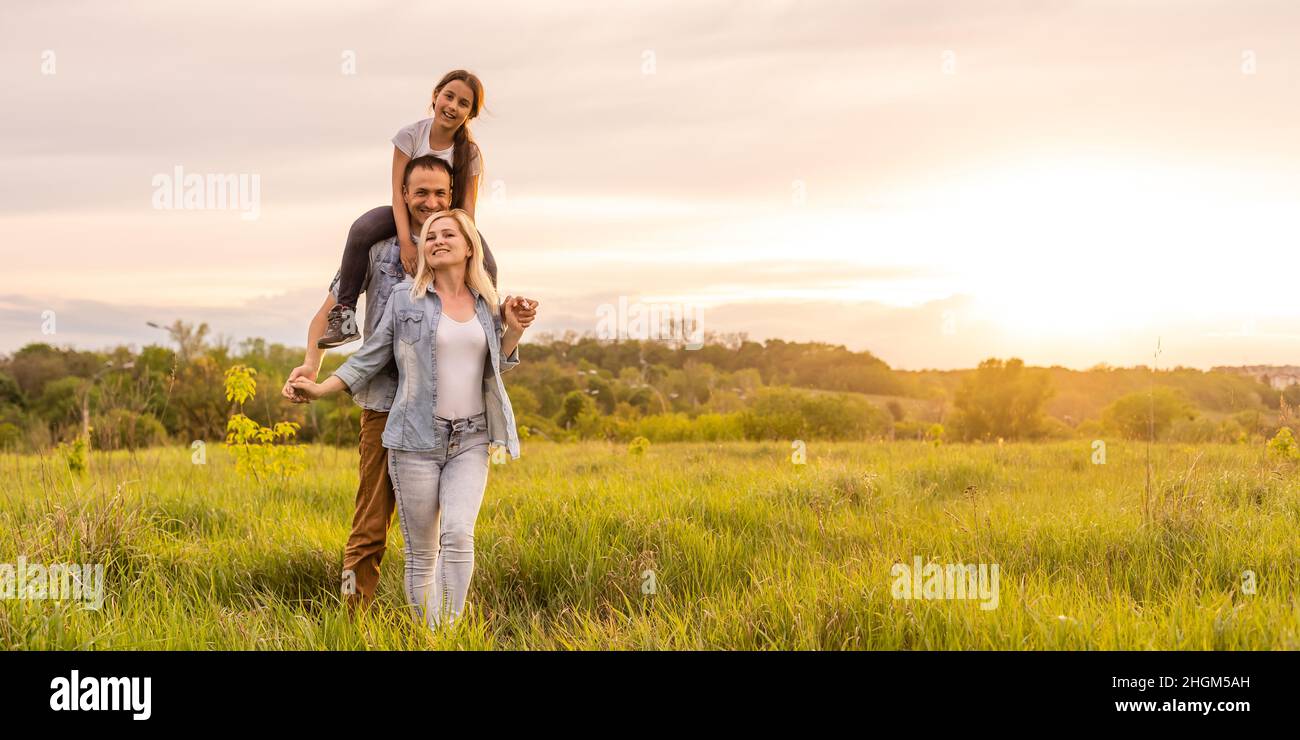 Happy family: mother father and child daughter on nature on sunset ...