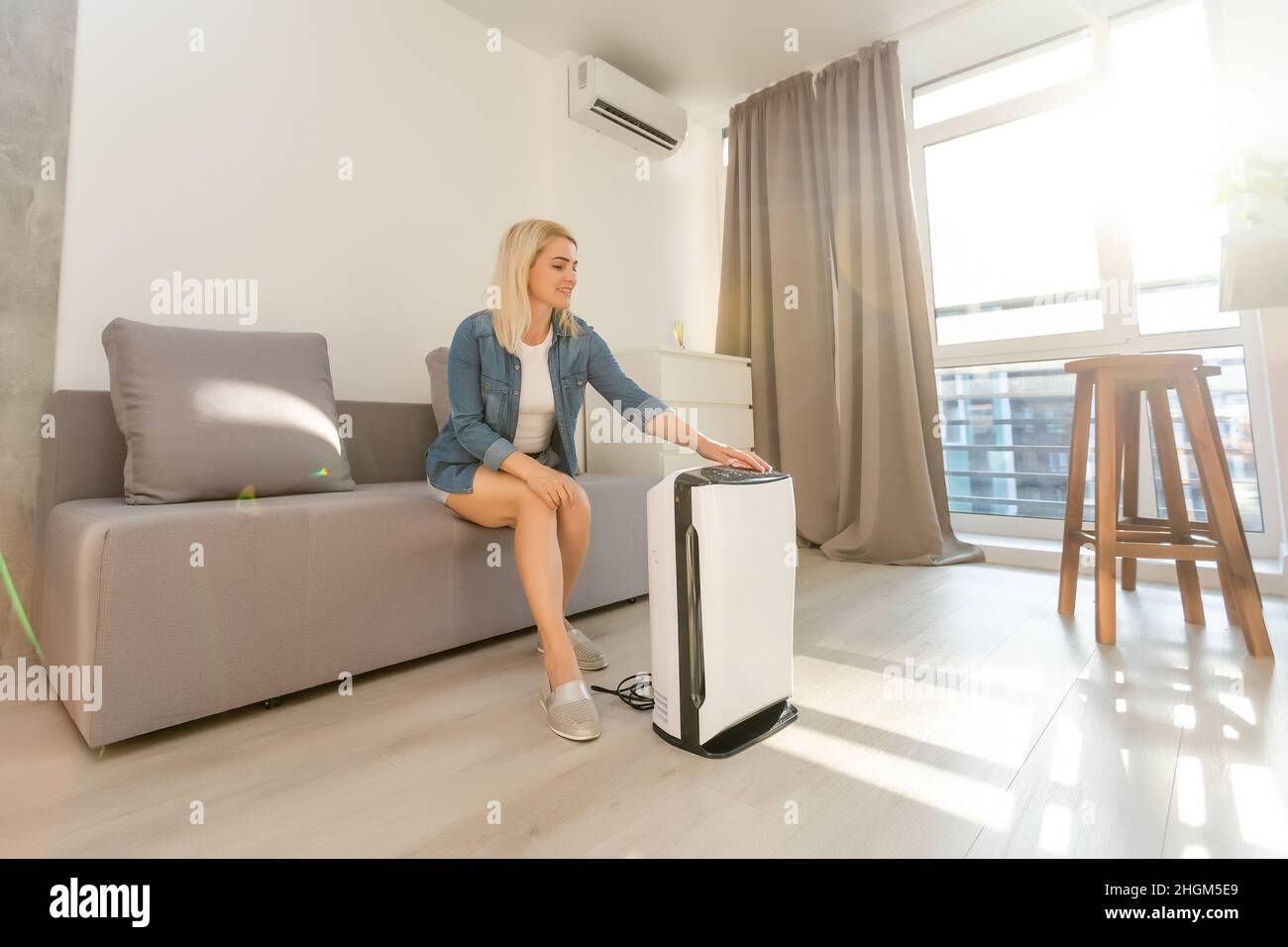 woman turn on air humidifier Stock Photo - Alamy