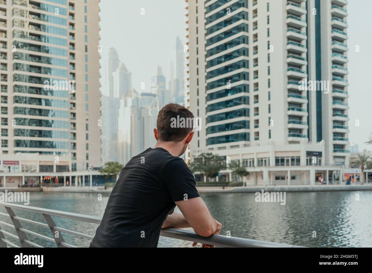 Young person standing outdoor and looking forward to the urban ...