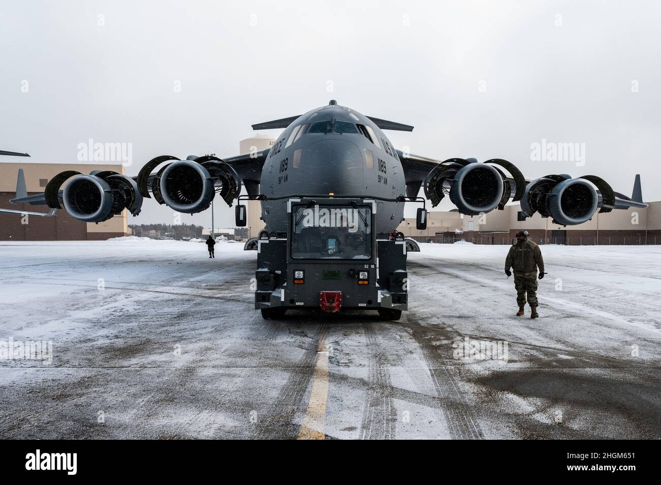 Airmen assigned to the 911th Aircraft Maintenance Squadron tow a C-17 ...