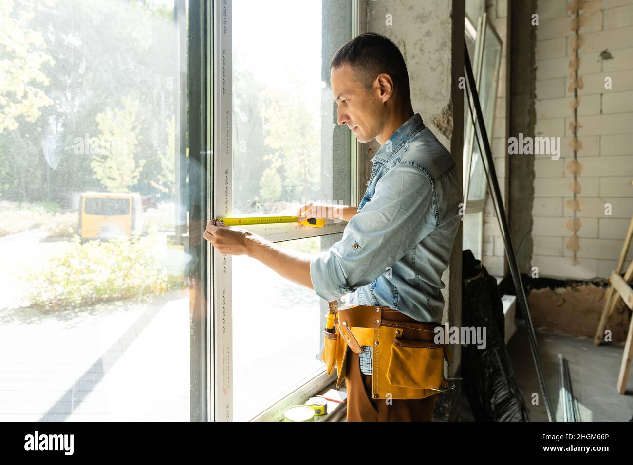 Construction worker installing window in house Stock Photo - Alamy