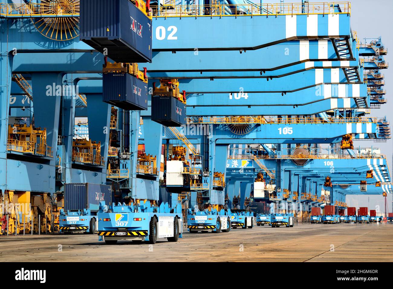 QINGDAO, CHINA - JANUARY 21, 2022 - Automatic guided vehicles shuttle ...