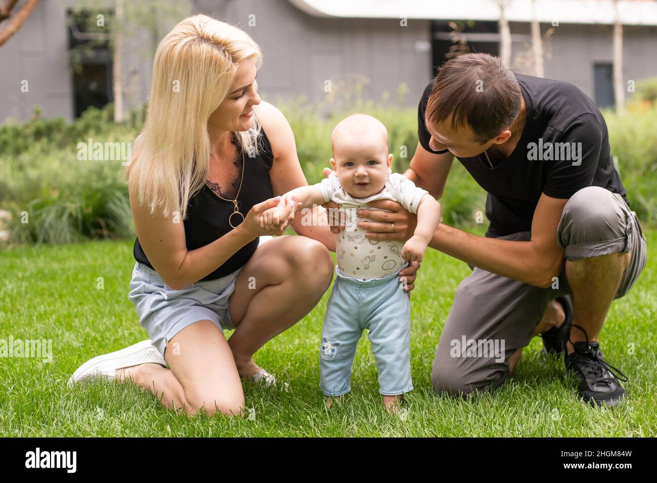 Happy family: mother father and child on nature Stock Photo - Alamy