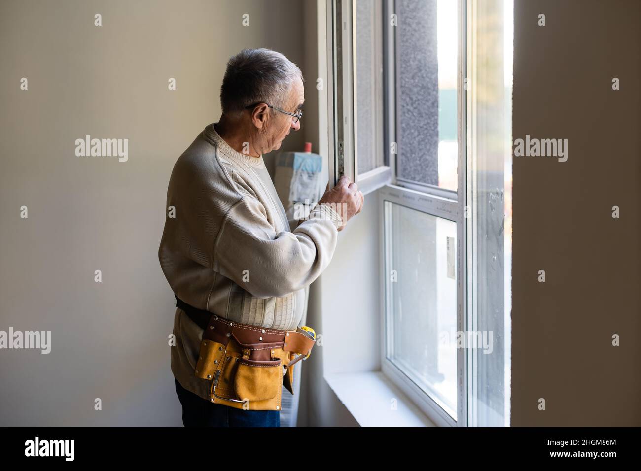 Windows installation worker. window customizer Stock Photo - Alamy