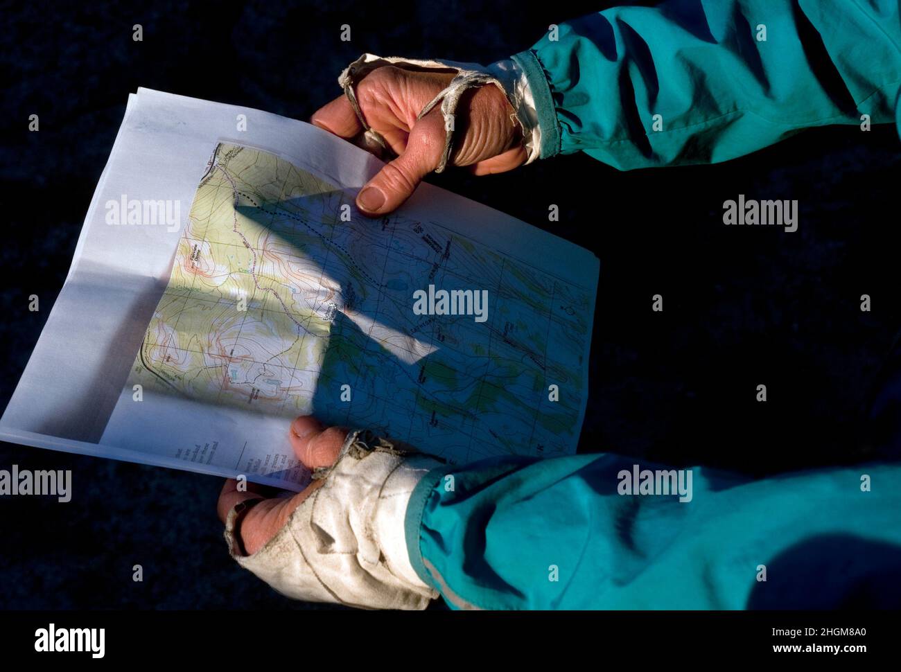 Rock climber reading a topographic map. Yosemite National Park ...