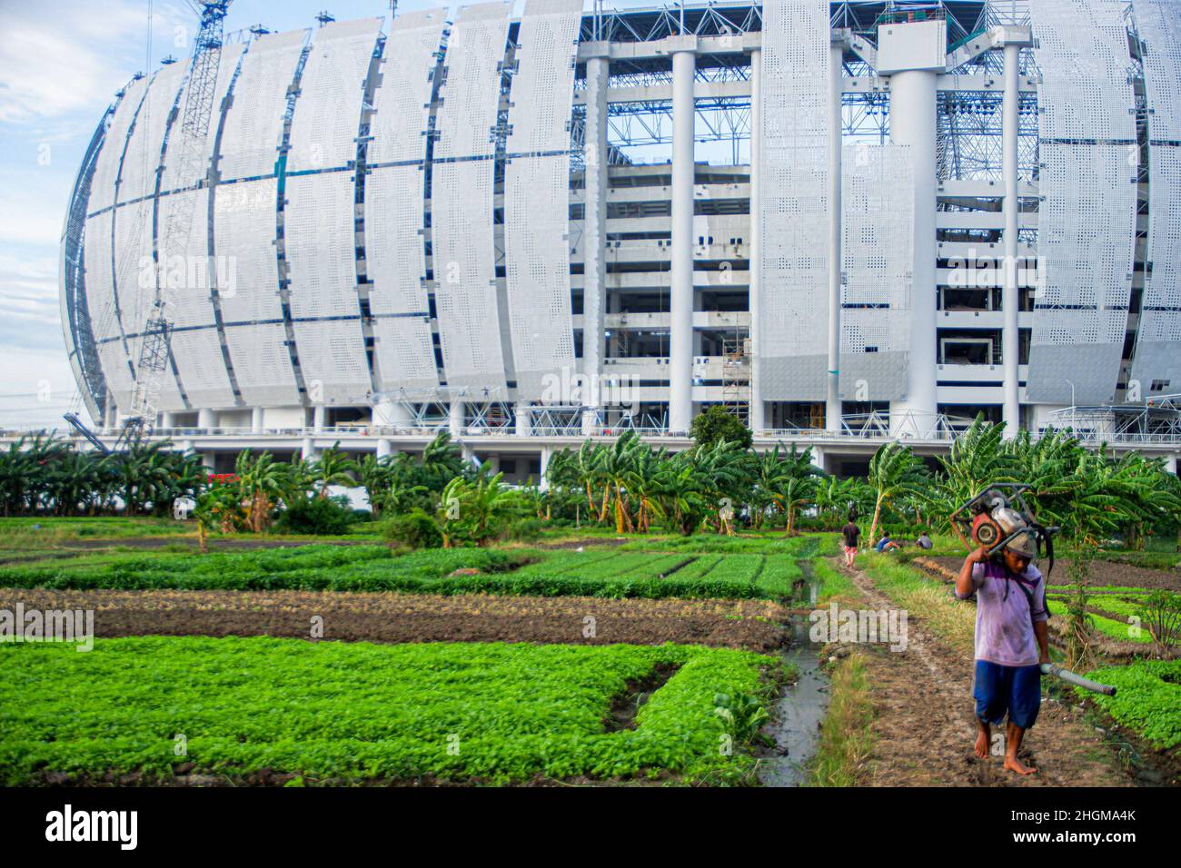 North Jakarta, Indonesia. 25th Dec, 2021. A farmer seen carrying ...