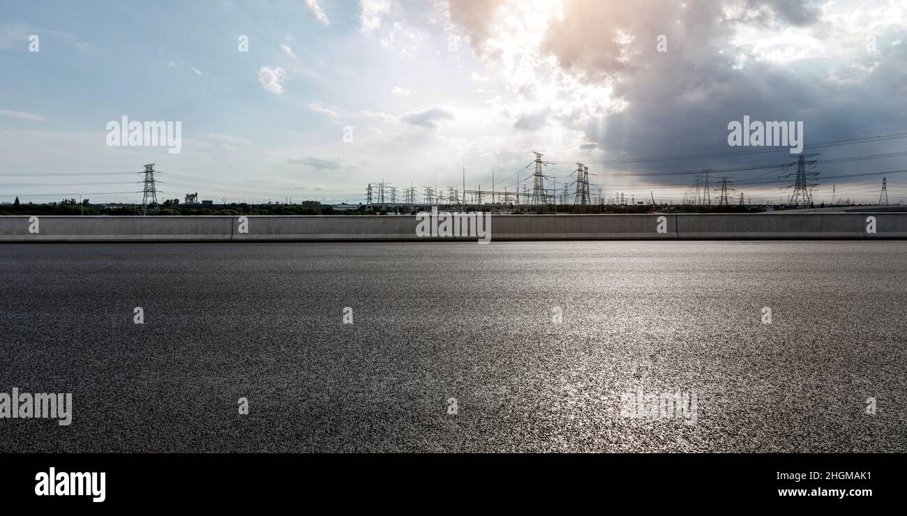 Empty asphalt road and high voltage power tower background Stock Photo ...