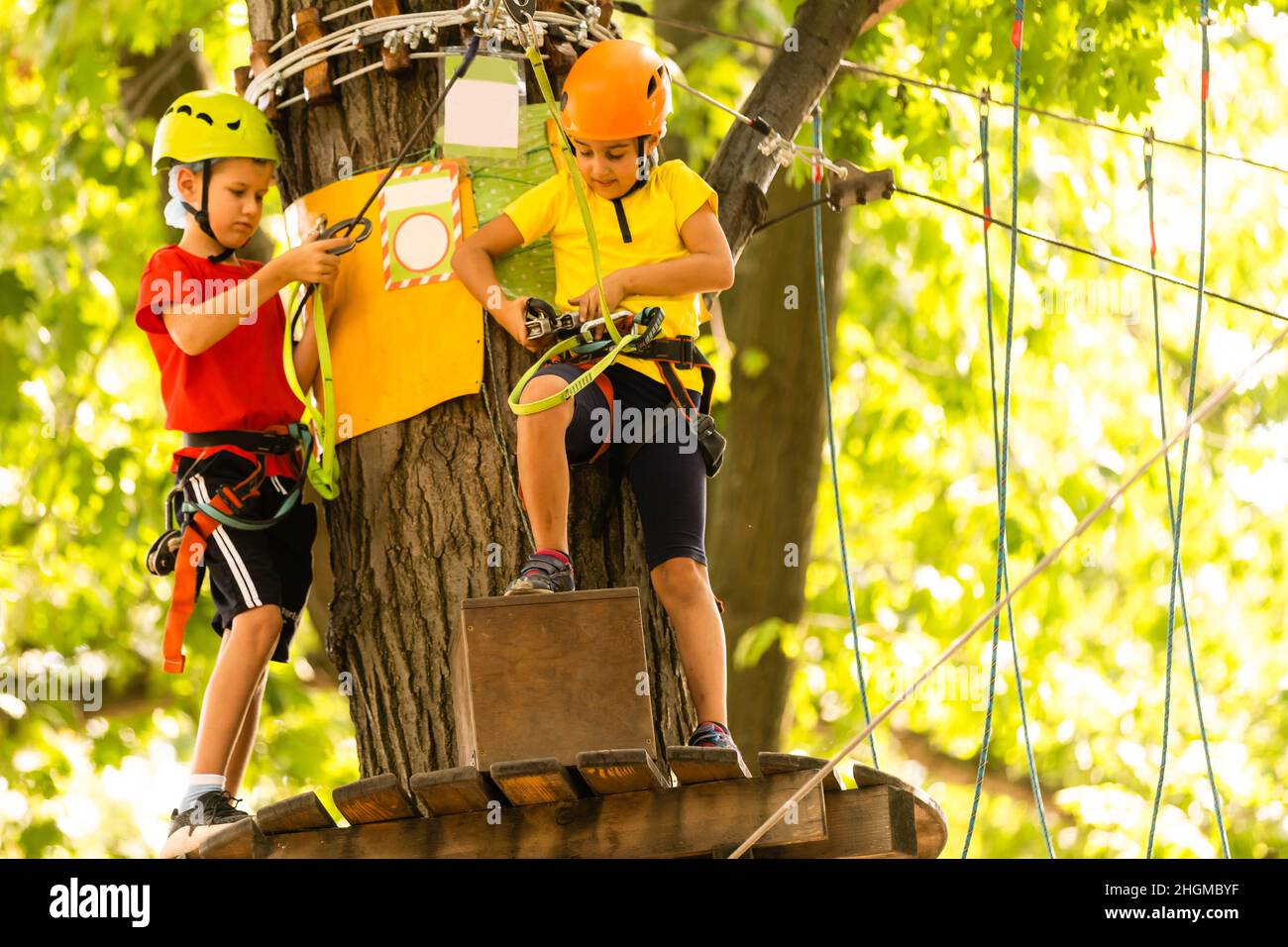 Happy child climbing in the trees. Rope park. Climber child. Early ...