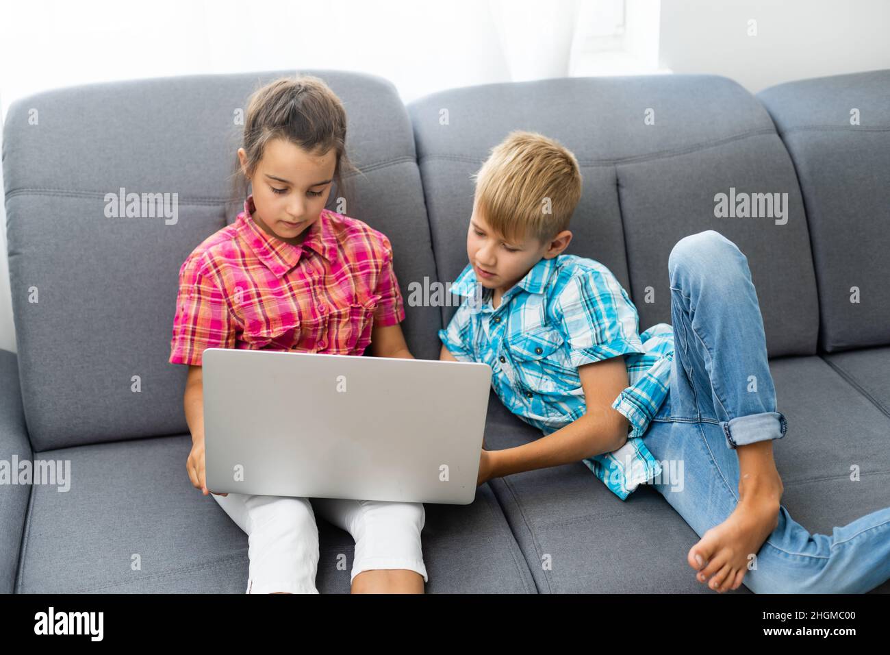 Kids playing with laptop computer at home Stock Photo - Alamy