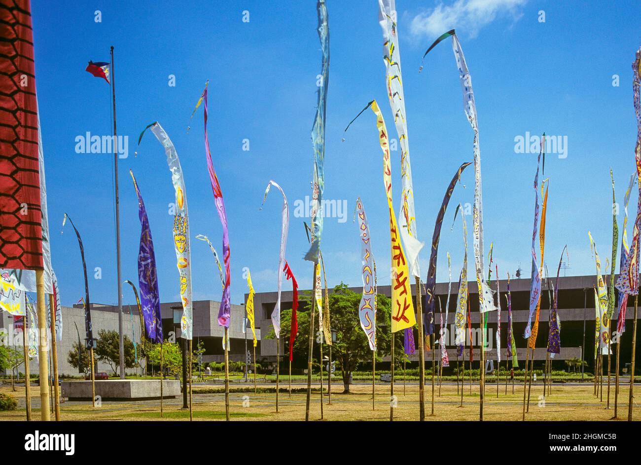 A collection of colourful flags flutter in the breezes off Manila Bay ...