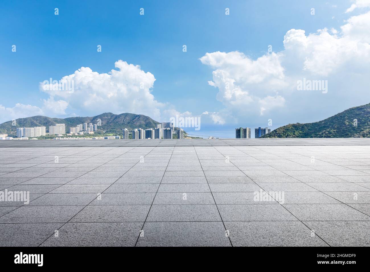 Empty square floor and modern city buildings with skyline by the sea ...