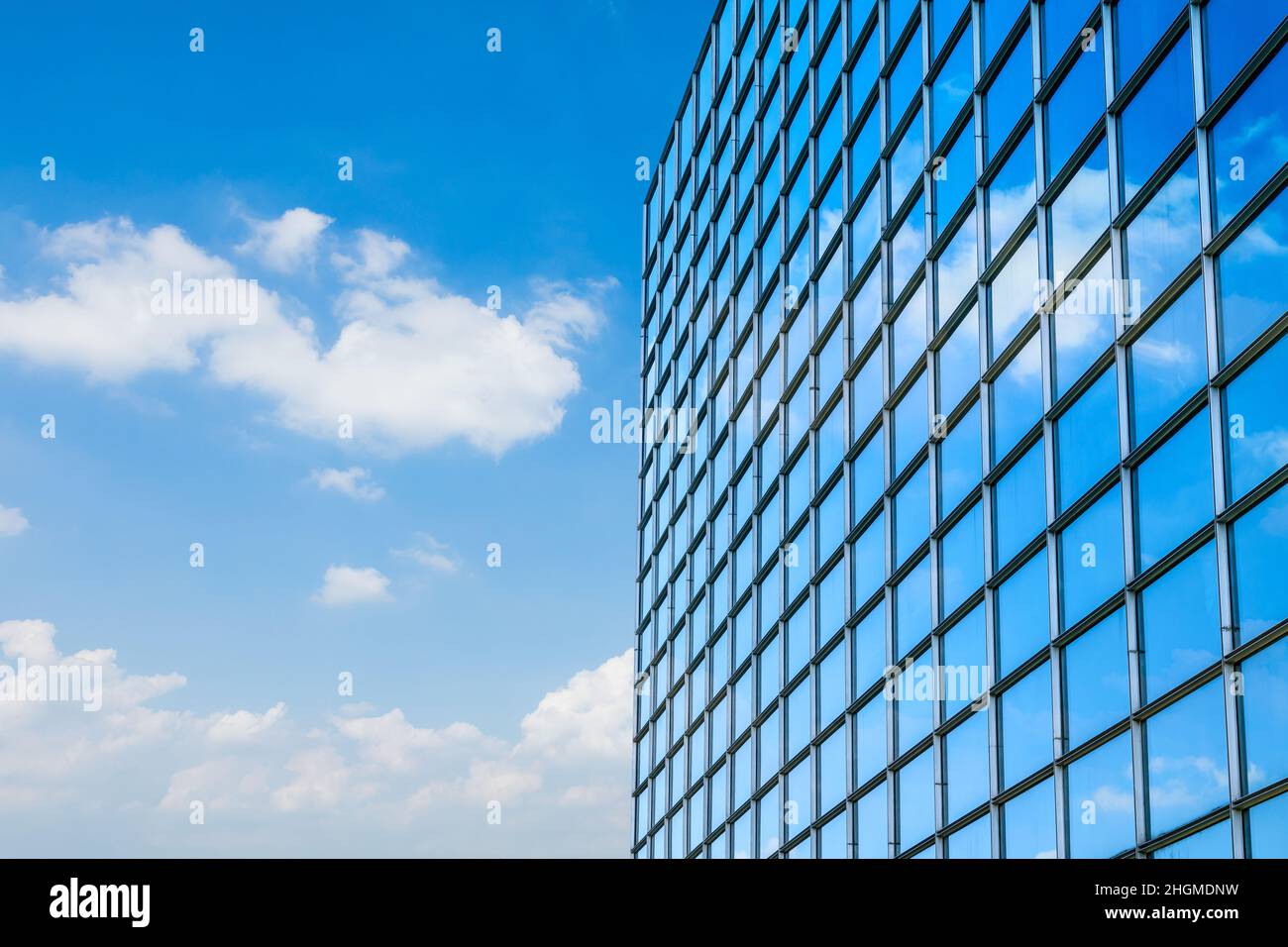 Modern Office Building With Glass Facade On A Clear Sky Background