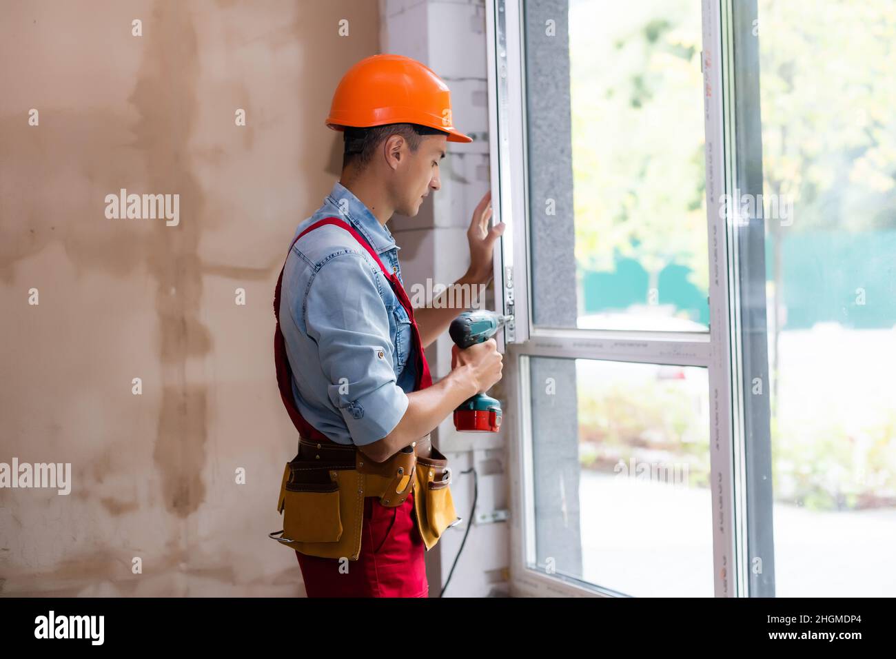 male industrial builder worker at window installation in building ...