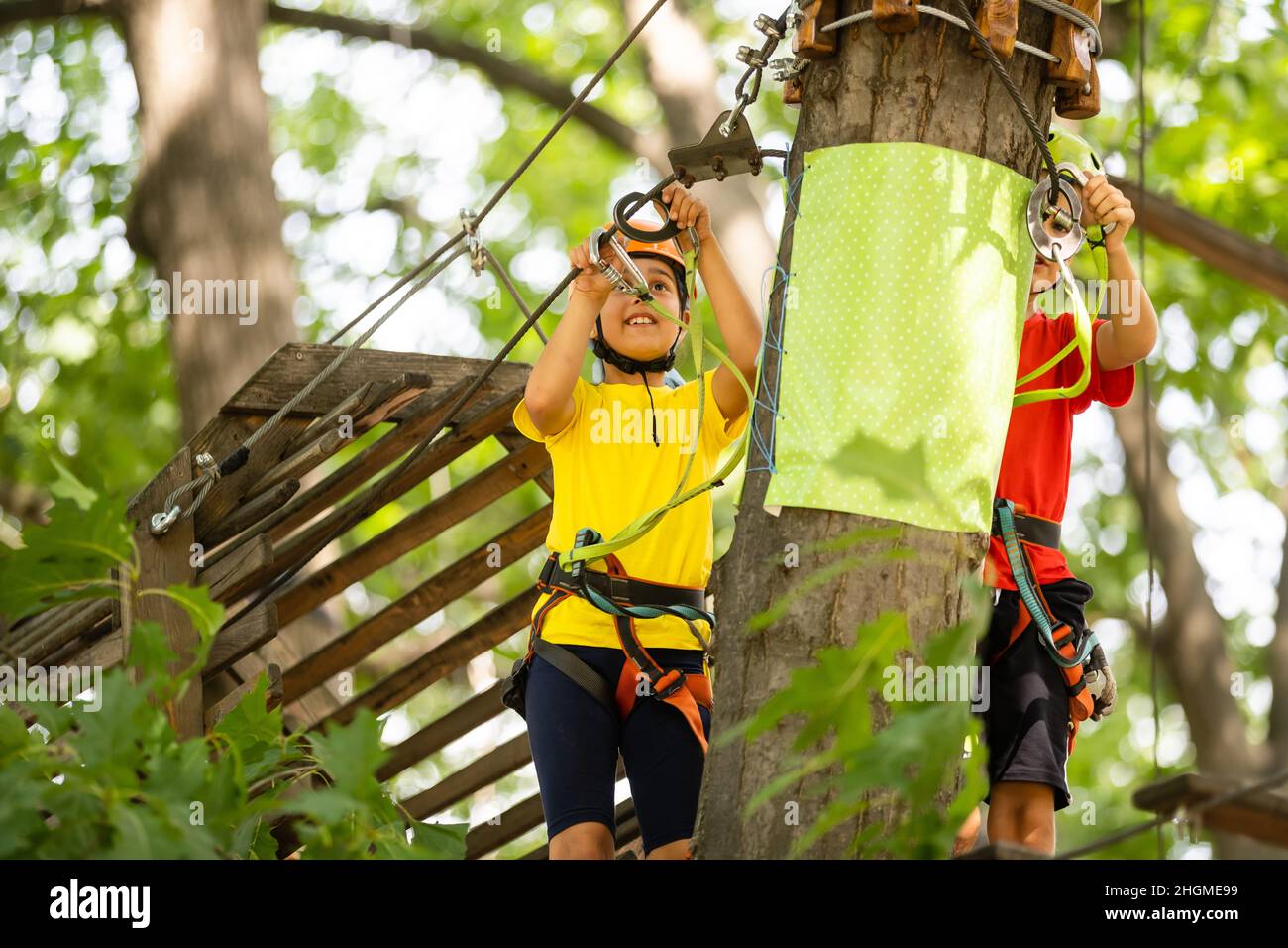 Happy child climbing in the trees. Rope park. Climber child. Early ...