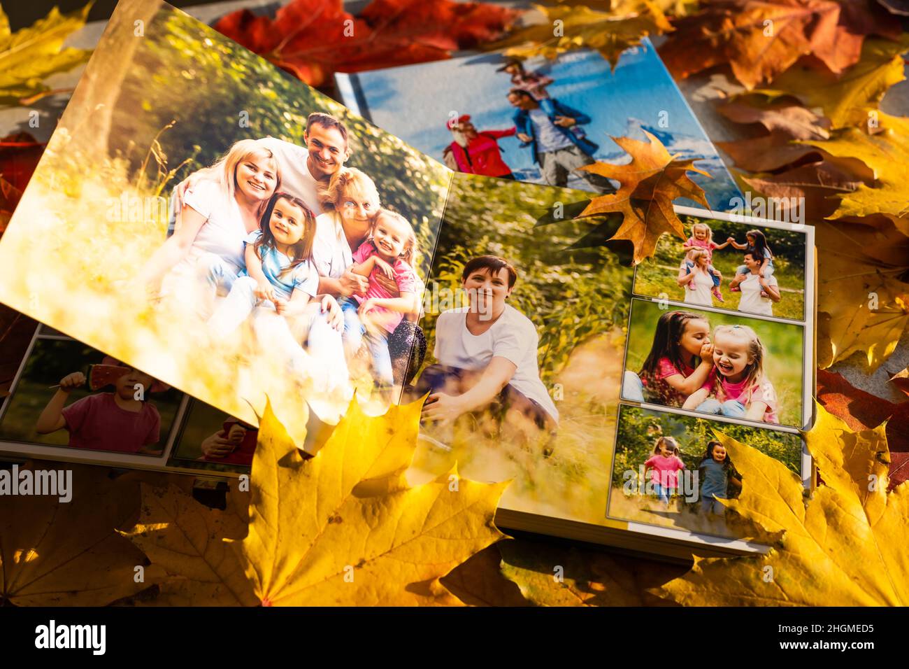 Autumn yellow leaves and family photobook. fall leaves arranged for a ...