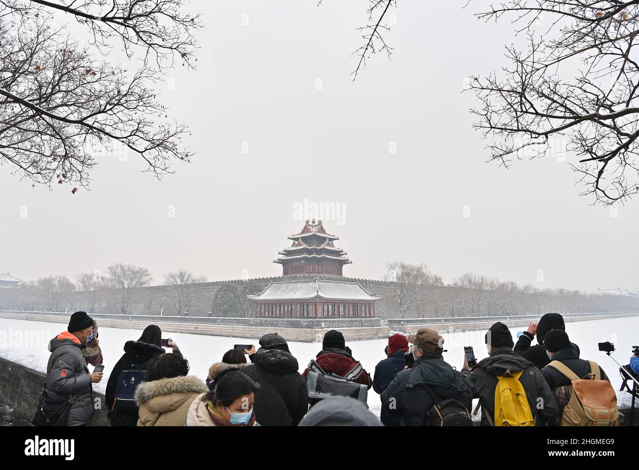 Beijing, China. 22nd Jan, 2022. Tourists take photos of a turret of the ...