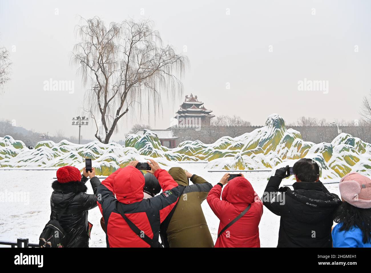 Beijing, China. 22nd Jan, 2022. Tourists take photos of a turret of the ...