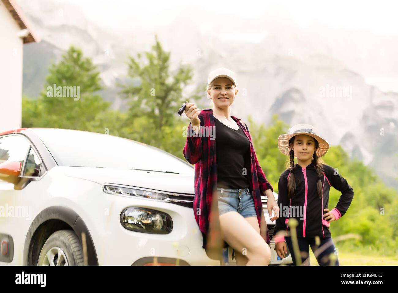 Happy driver woman against mountains background. Summer vacations ...