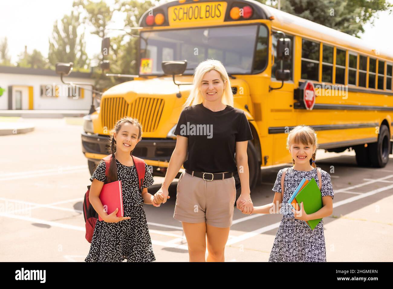 Back to school. Pupils of primary school near school bus. Happy ...