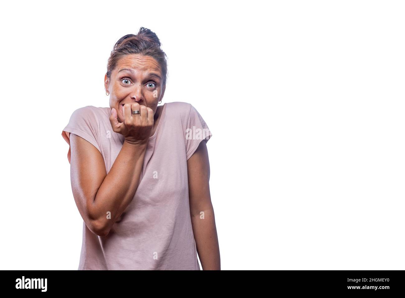 A nervous woman with her hand over her mouth Stock Photo - Alamy