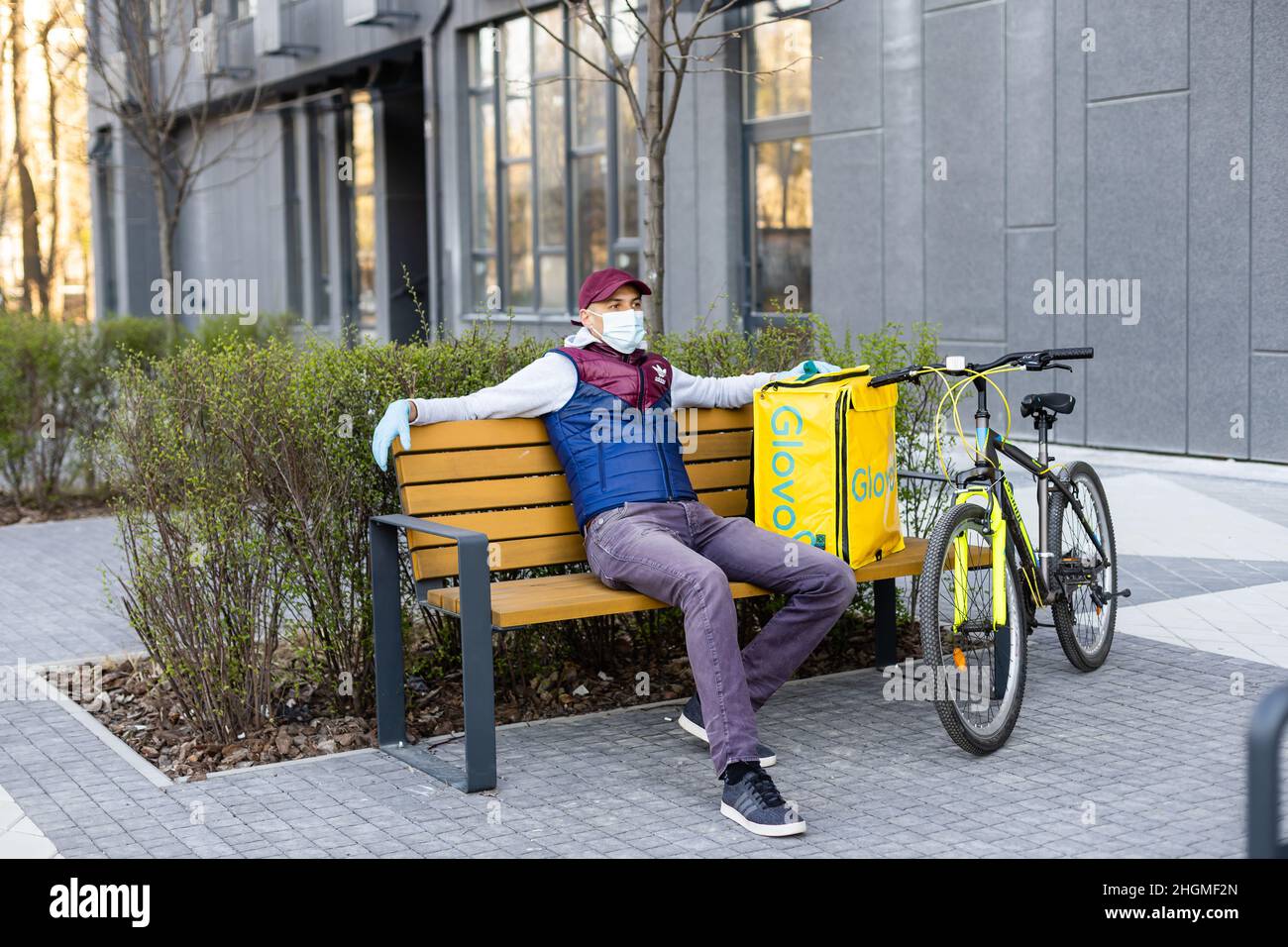 KIEV, UKRAINE - 28 April, 2021: Glovo delivery boy with famous yellow ...